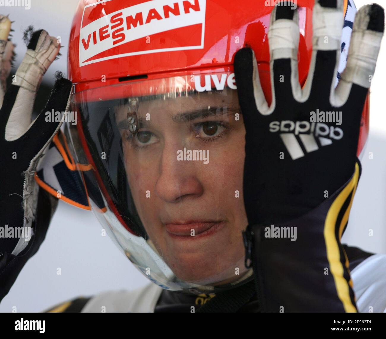 Natalie Geisenberger of Germany adjusts her facemask before her first ...
