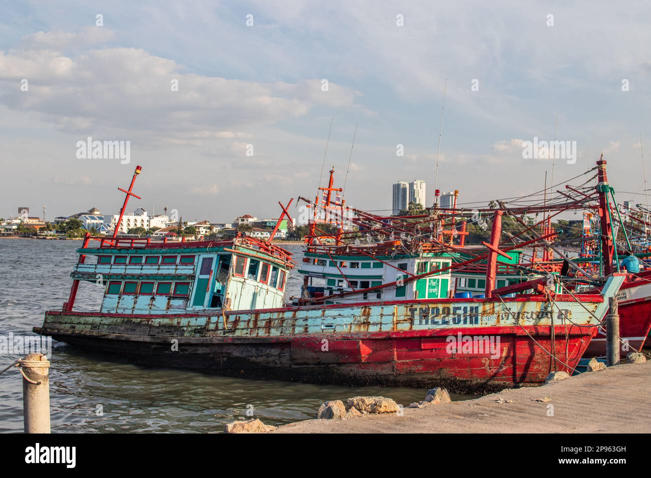 Thai fishing boats at a pier or wharf in Thailand Southeast Asia Stock Photo - Alamy