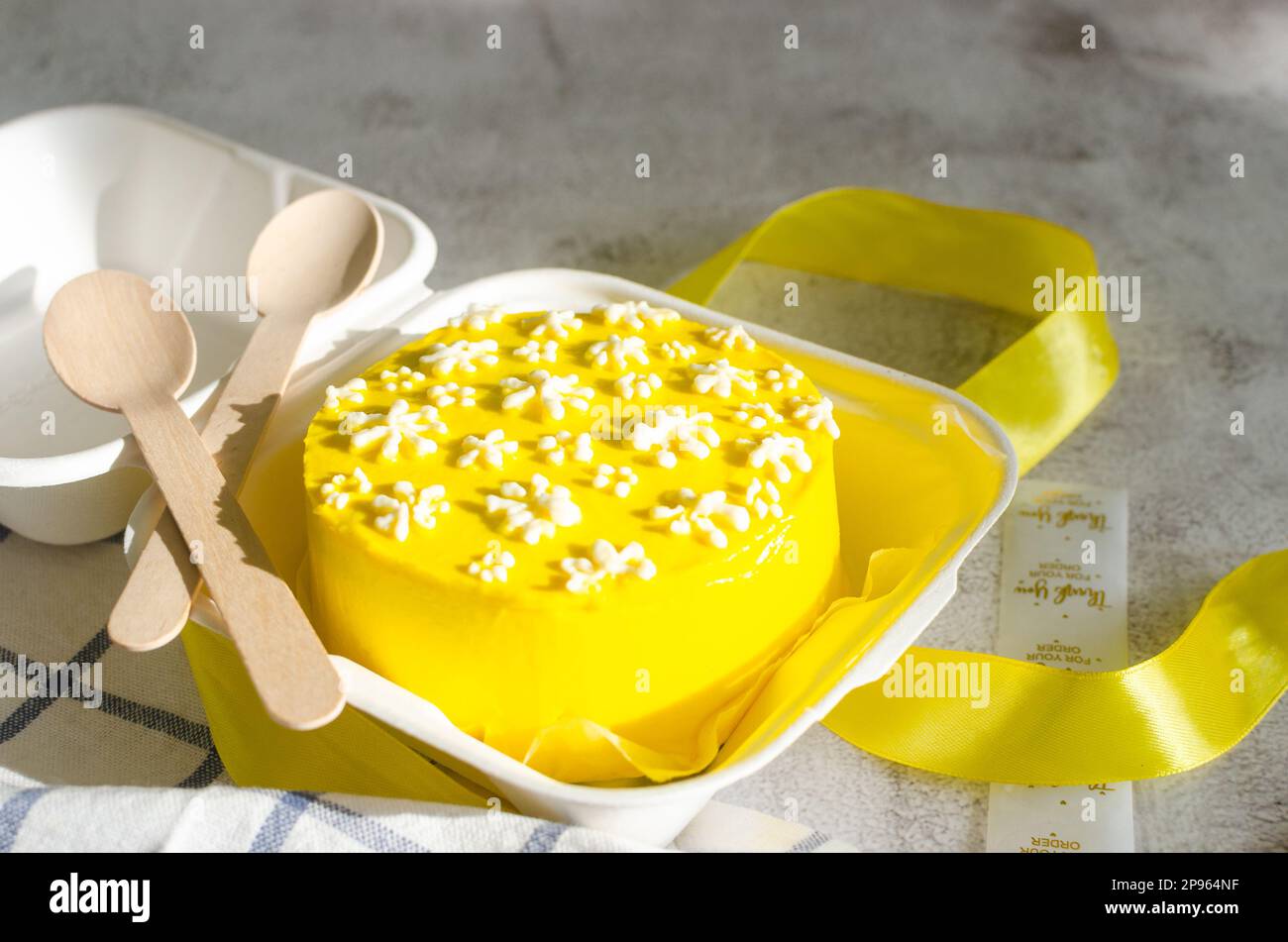 Trendy bento cake yellow color with cute decor on light background ...