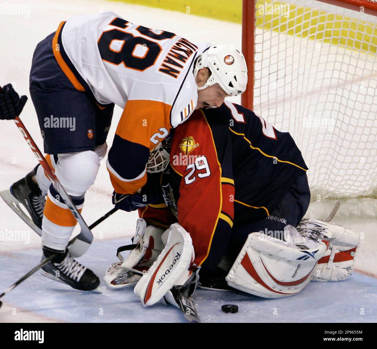 New York Islanders forward Tim Jackman, left, collides with Florida ...