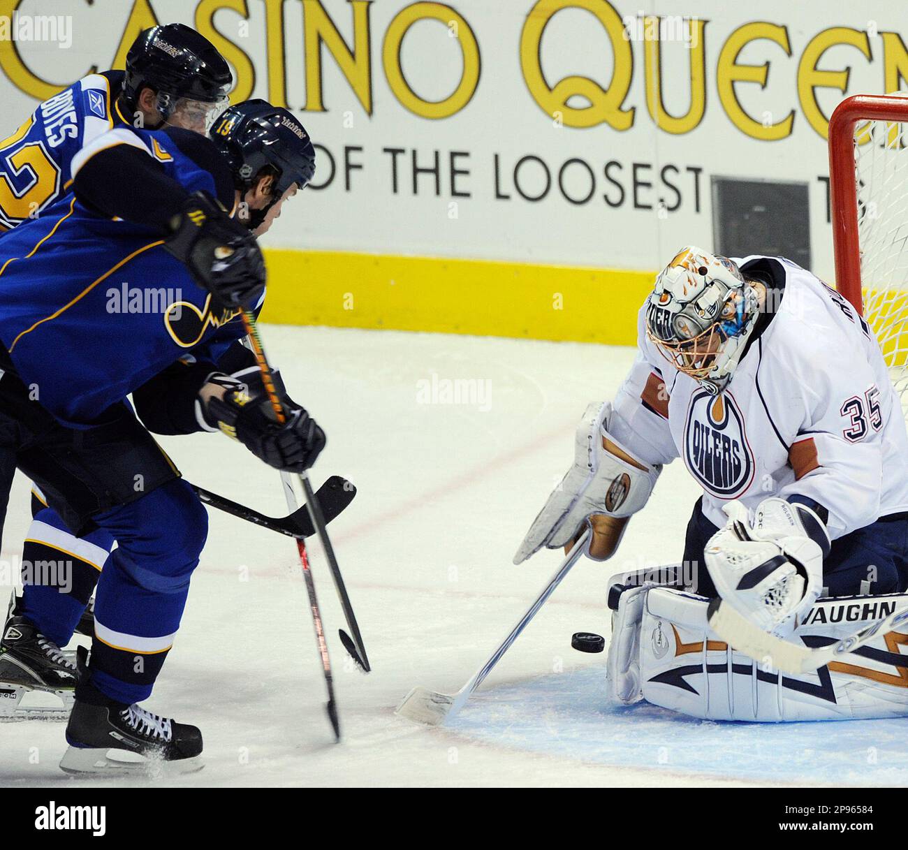 Edmonton Oilers goalie Dwayne Roloson (35) blocks a shot in front of St ...