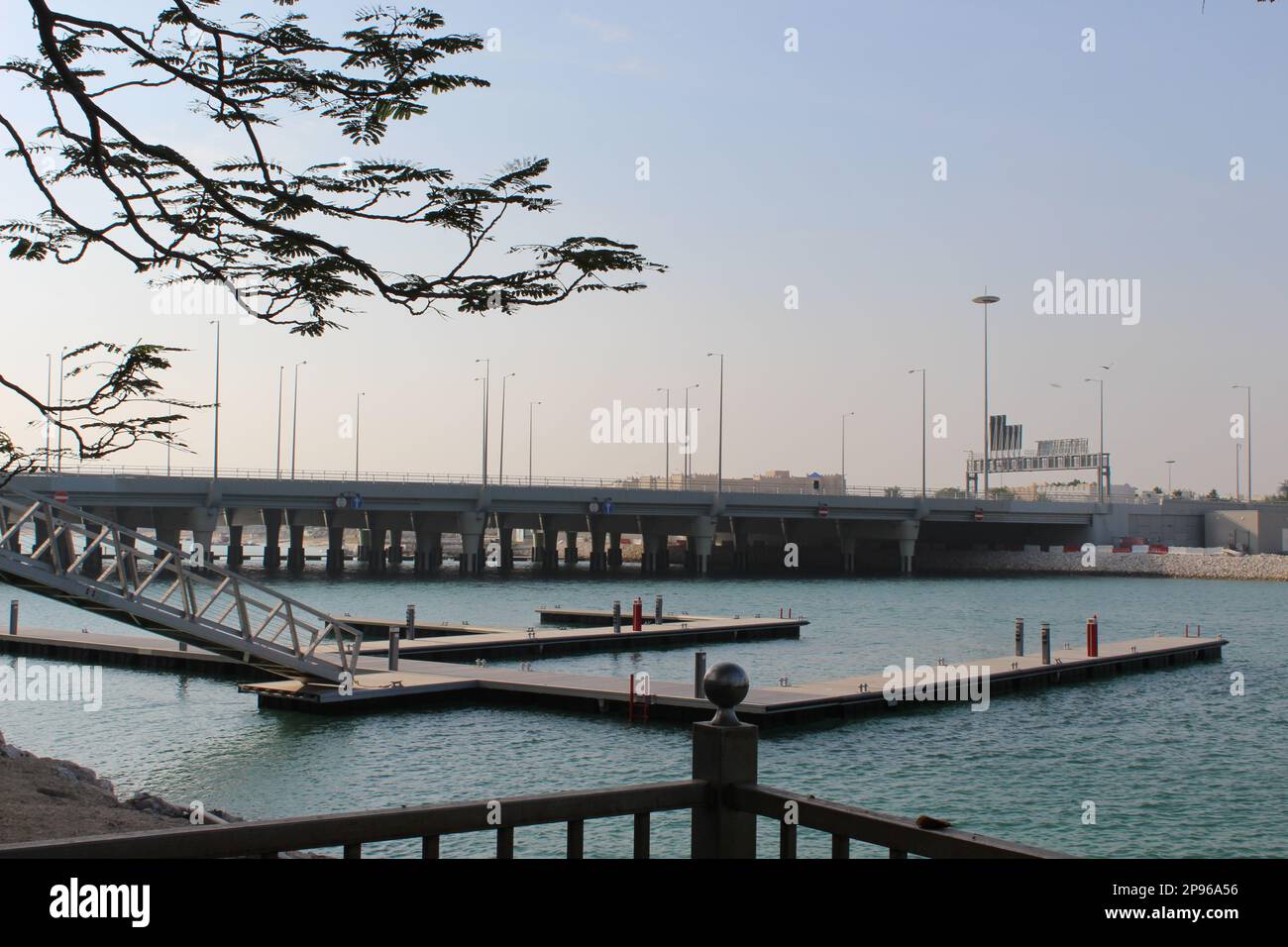 An empty dock by a bridge during sunset in Doha, Qatar Stock Photo - Alamy