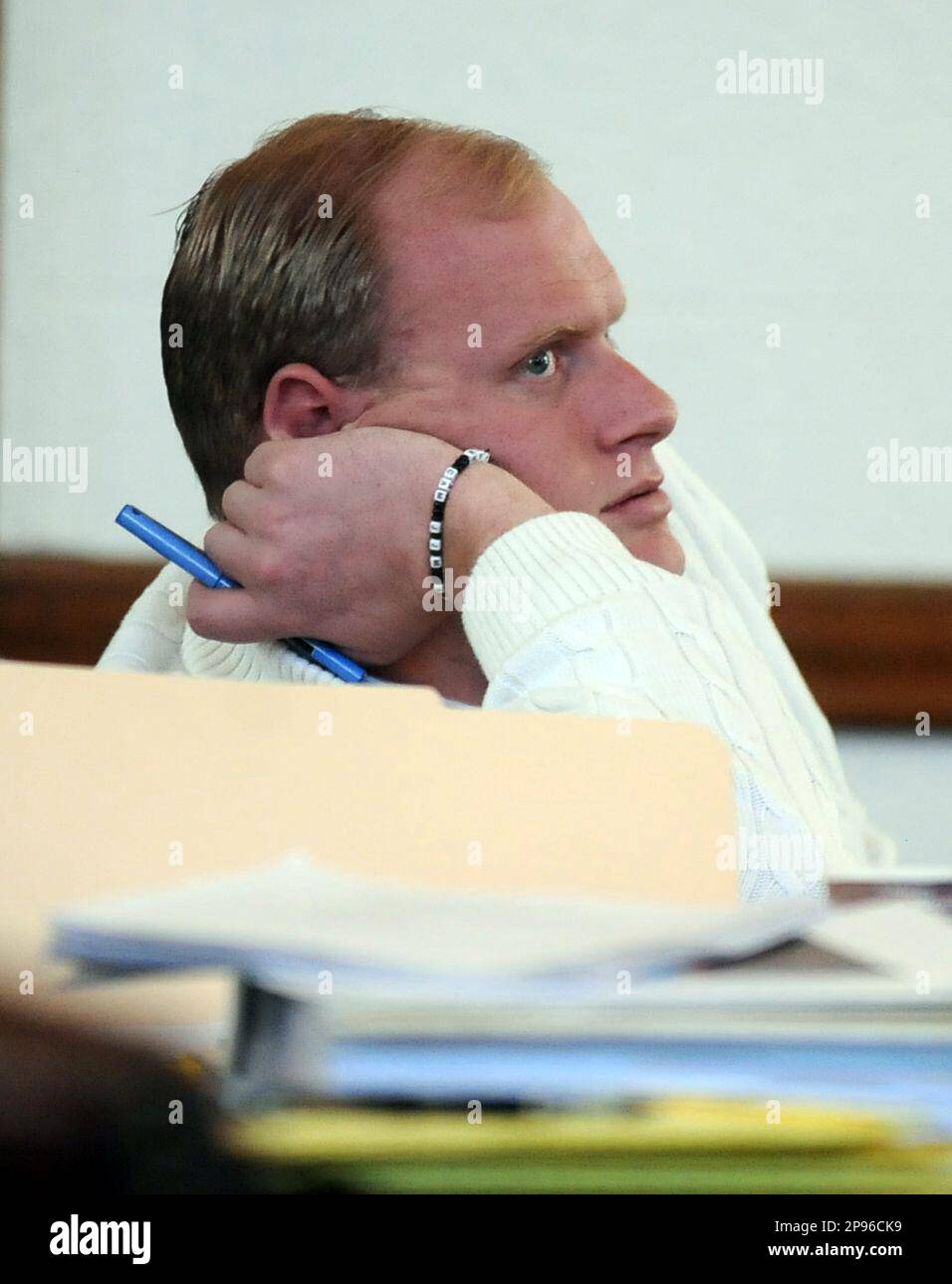 Alex Midyette listens to his mother Kay Midyette's testimony during his ...