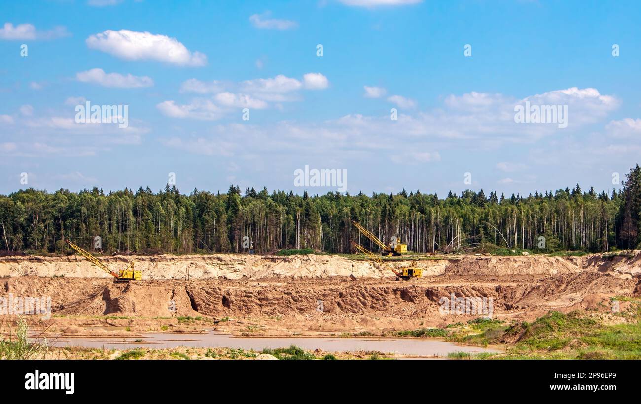 Industrial quarry. Sand mining. Excavators against the backdrop of ...