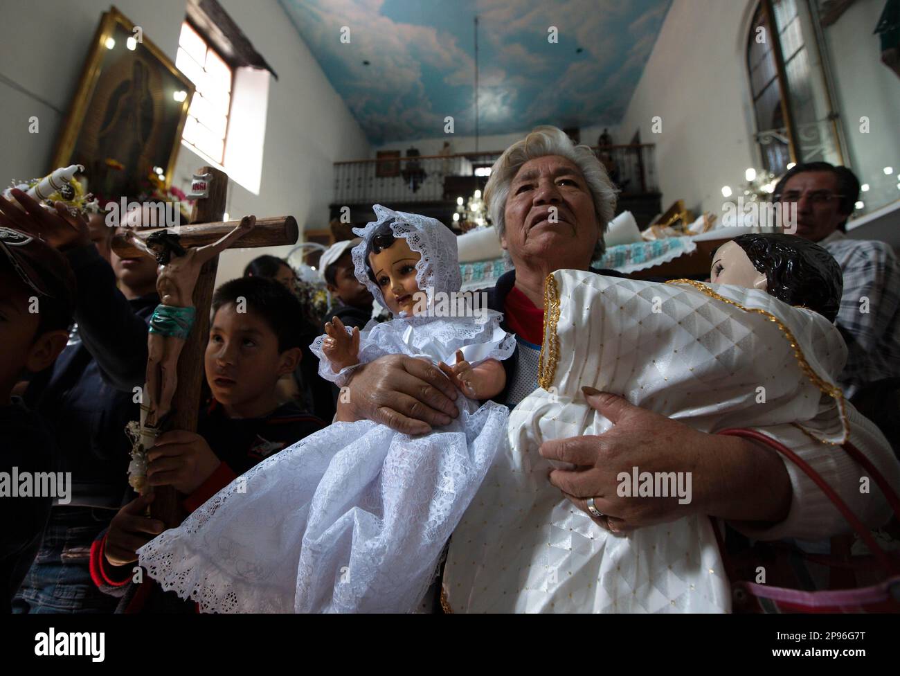 People hold depictions of the baby Jesus during a celebration of the ...