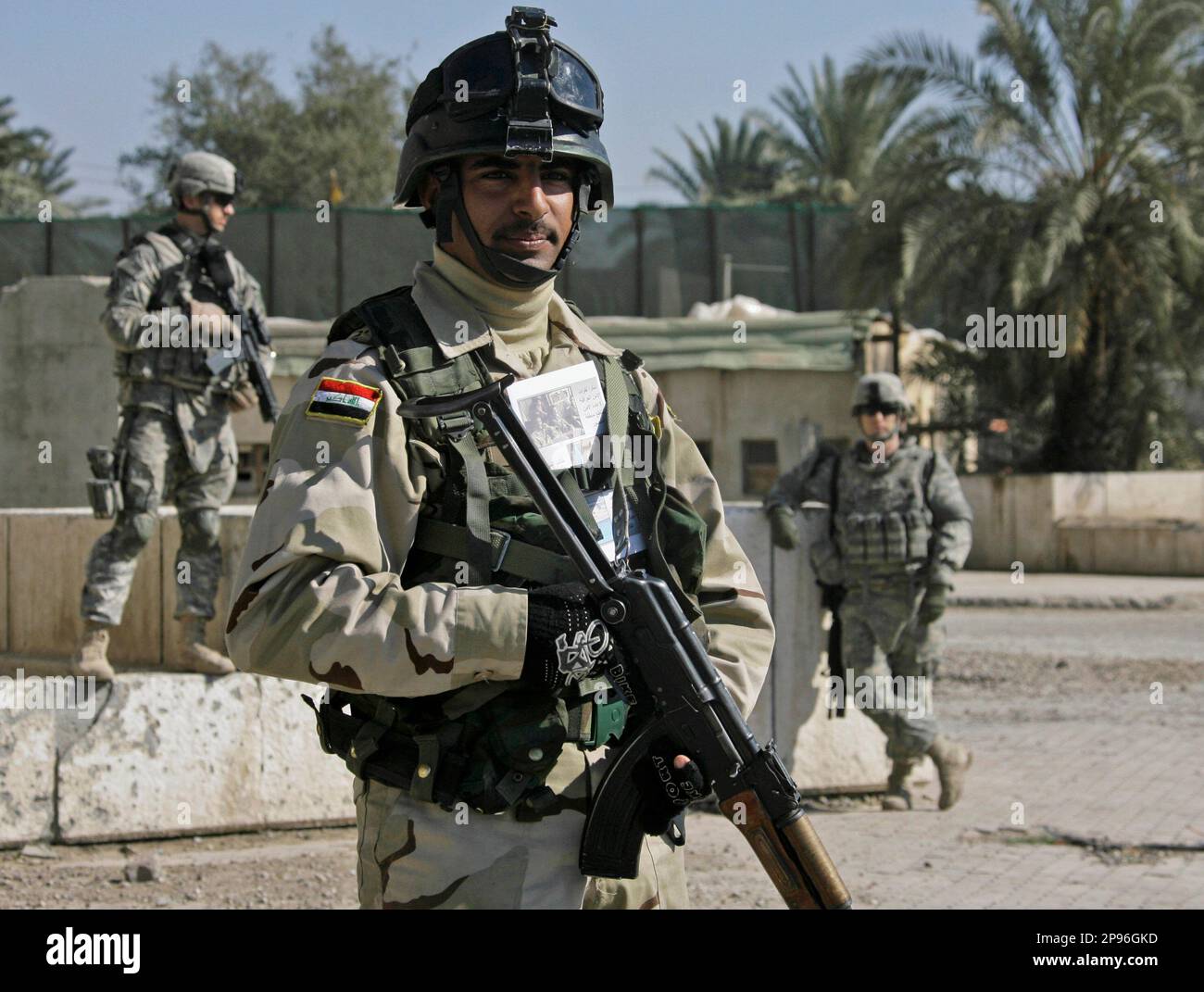 An Iraqi Army soldier stands guards during a handover ceremony for the ...