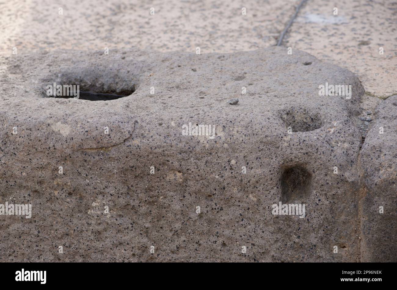 Detail of a kerbstone at pompeii with holes, possibly to tether an ...