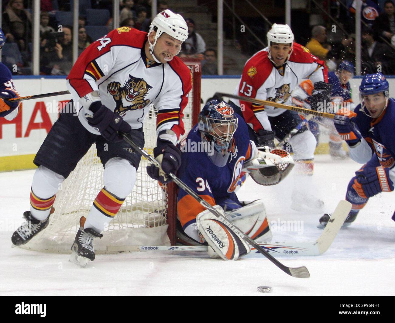 New York Islanders goalie Yann Danis, center, defends the goal as ...
