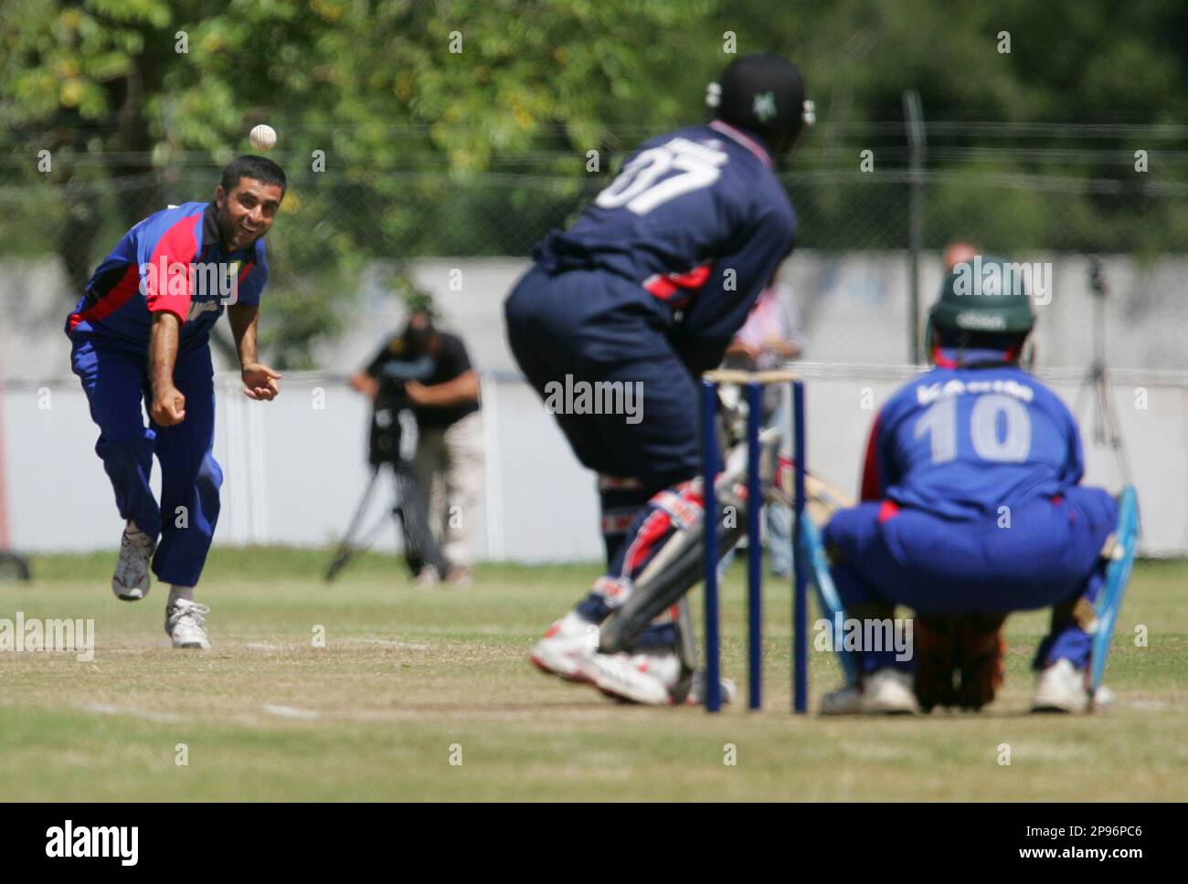 Afghanistan's Hasti Gul Abed, left, bowls during an ICC World Cricket ...