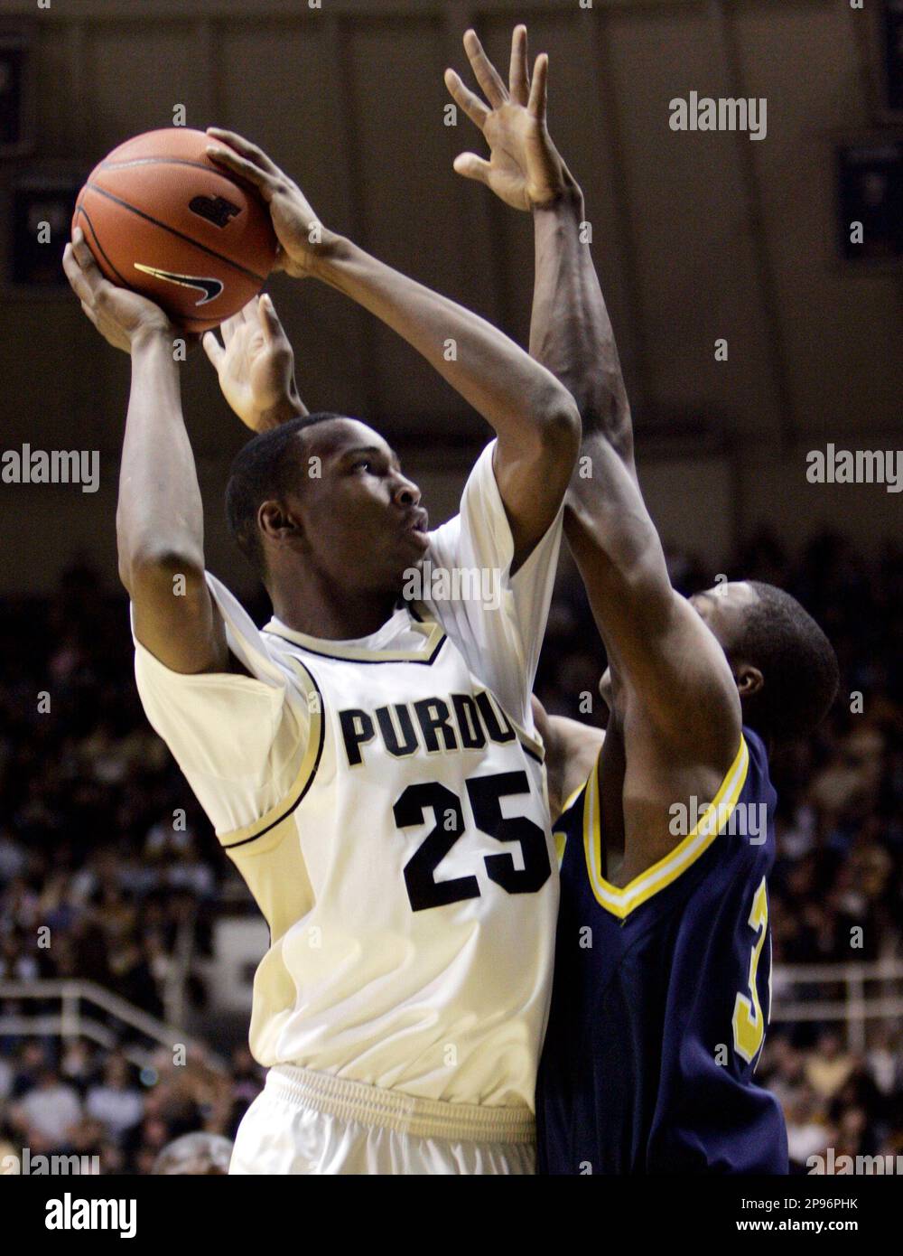 Purdue forward JaJuan Johnson, left, shoots over Michigan forward ...