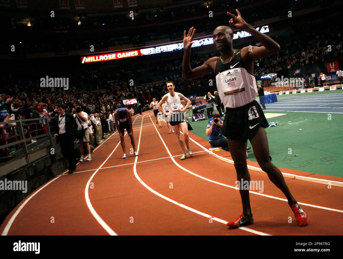 Bernard Lagat, of the United States, holds up seven fingers in ...