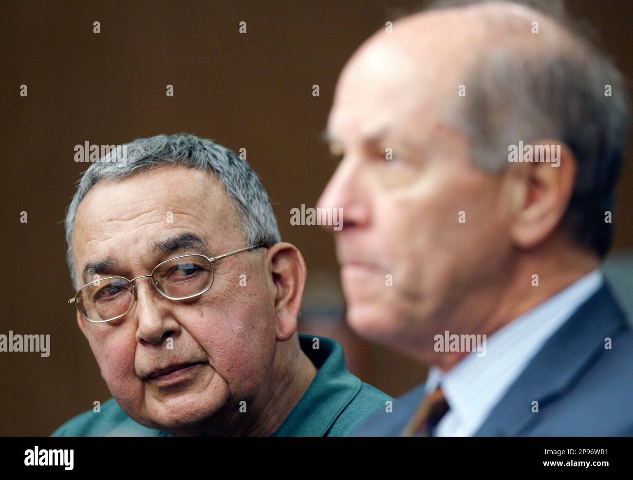 Former Roman Catholic priest George Miller, left, looks at his attorney ...