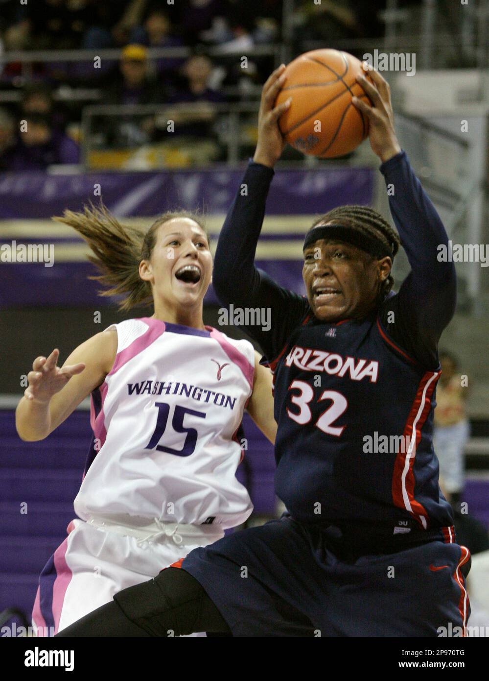 Arizona's Amina Njonkou (32) pulls down a rebound in front of ...
