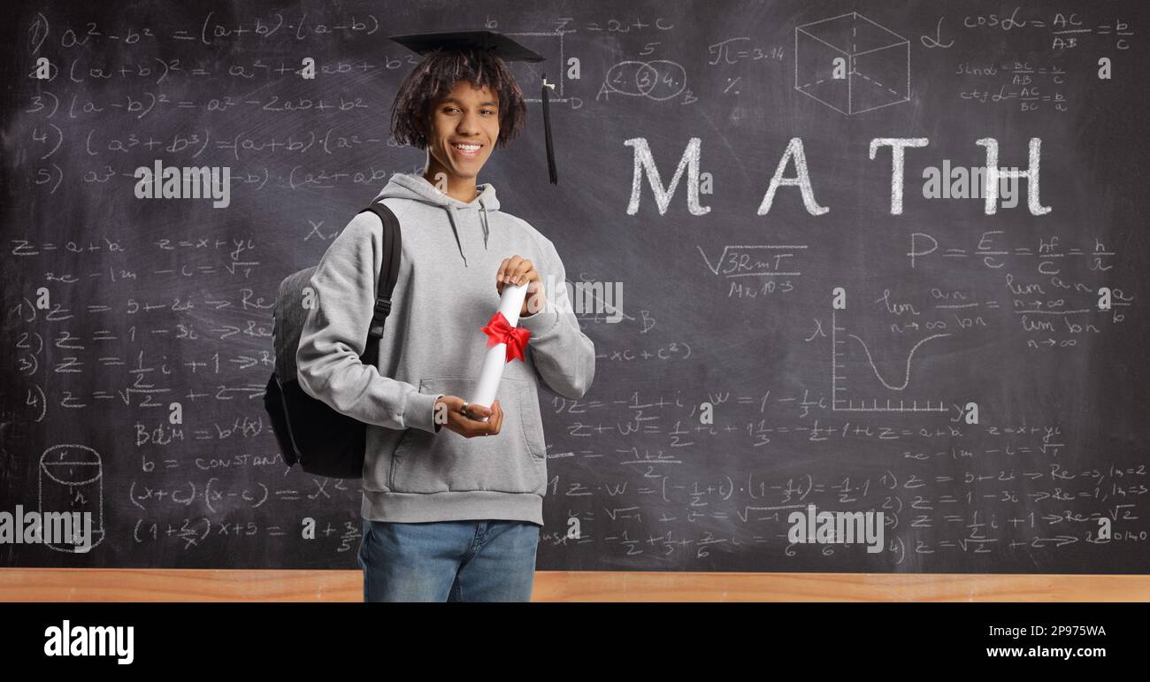 African american male student holding a diploma and posing in front of ...
