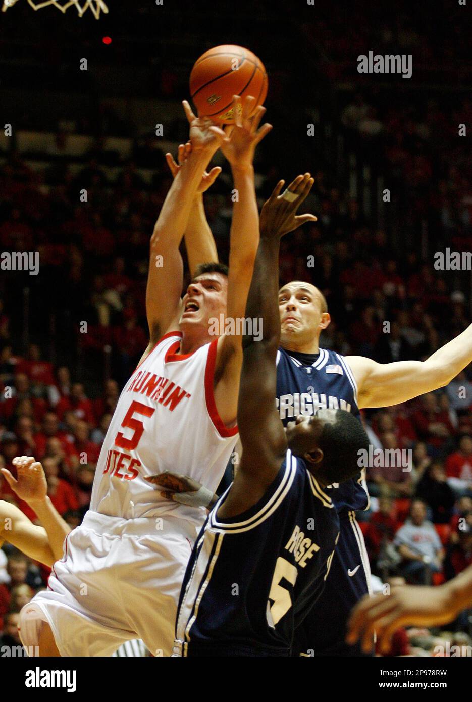 Utah guard Luka Drca, left, is fouled while being defended by Brigham ...