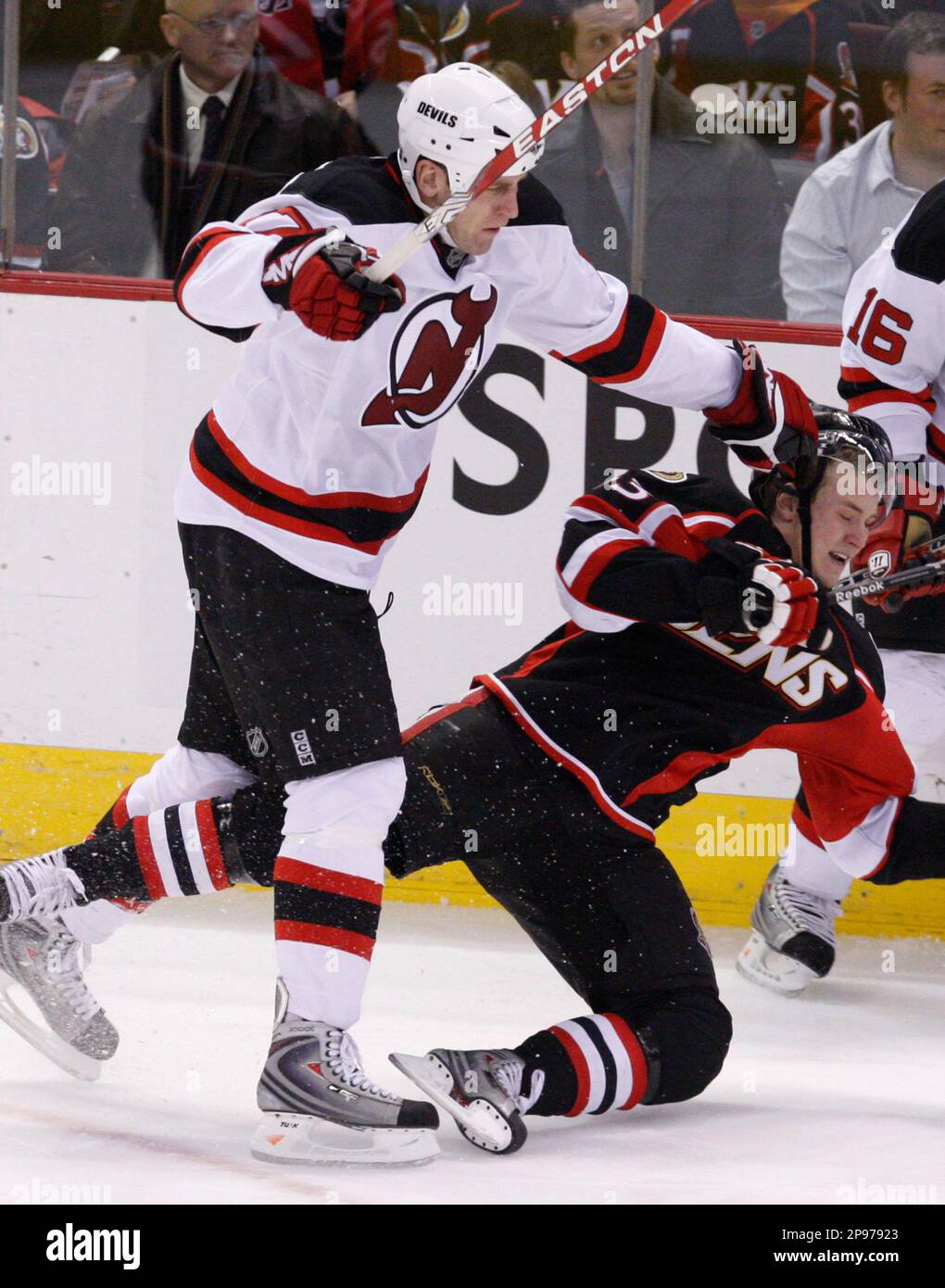 New Jersey Devils' Mike Rupp (17) knocks down Ottawa Senators' Peter ...