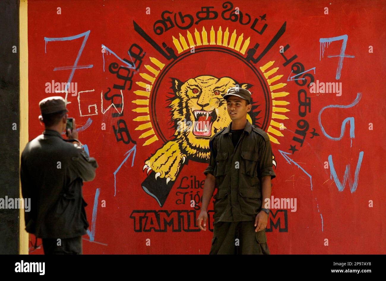 Sri Lankan army soldiers take photographs of each other outside an ...