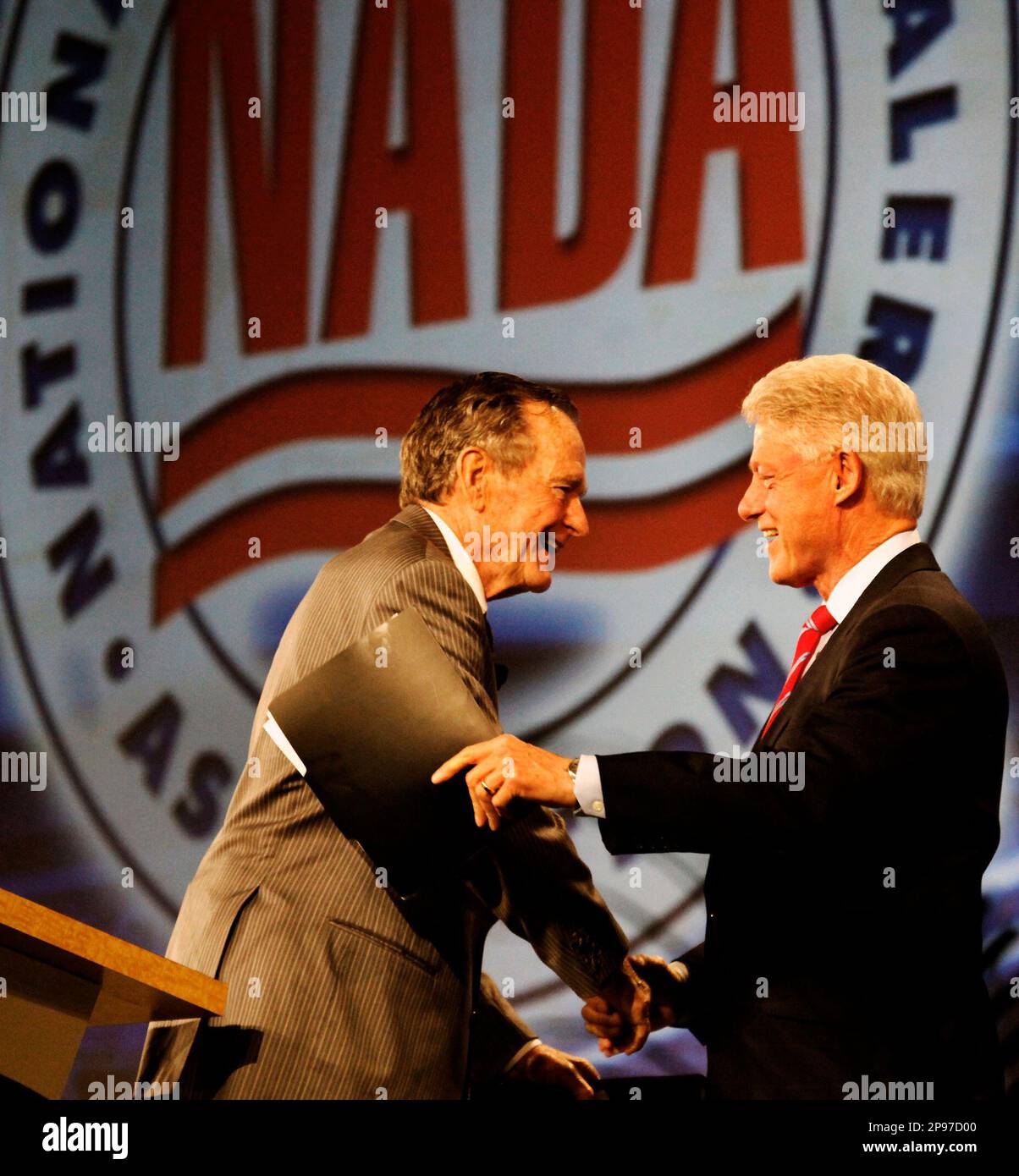 Former Presidents George H. W. Bush and Bill Clinton greet each other ...
