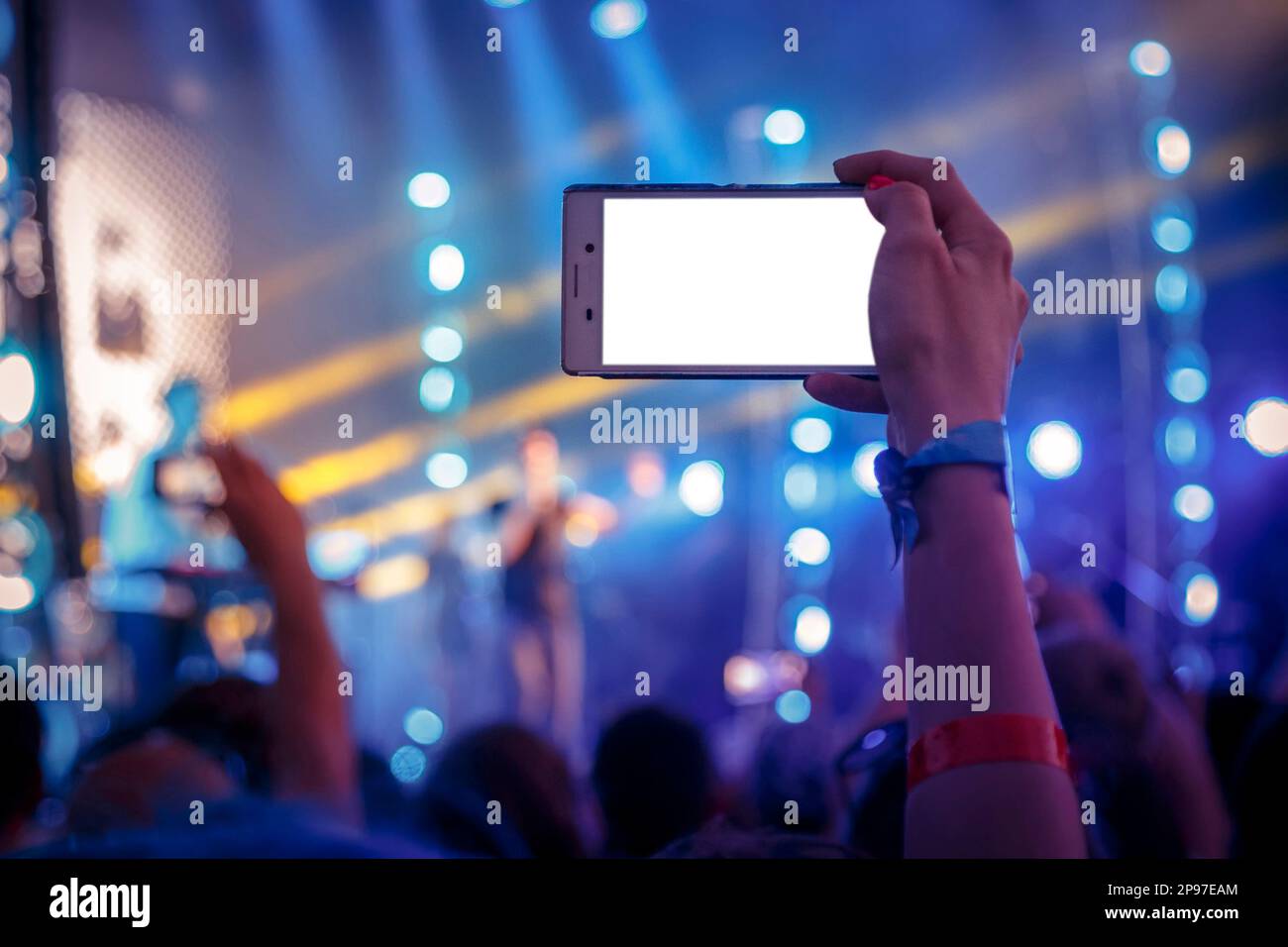 A mobile phone in the hands of young people with an isolated screen for ...