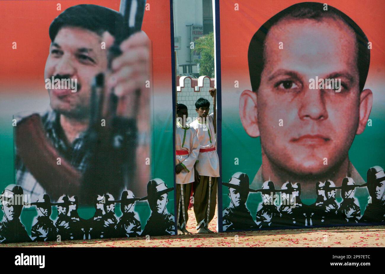 School children hold the photographs of Indian police officers, Vijay ...