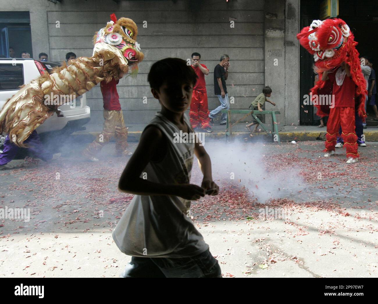 Dragon dancers perform around exploding firecrackers to celebrate the Chinese New Year at Manila ...