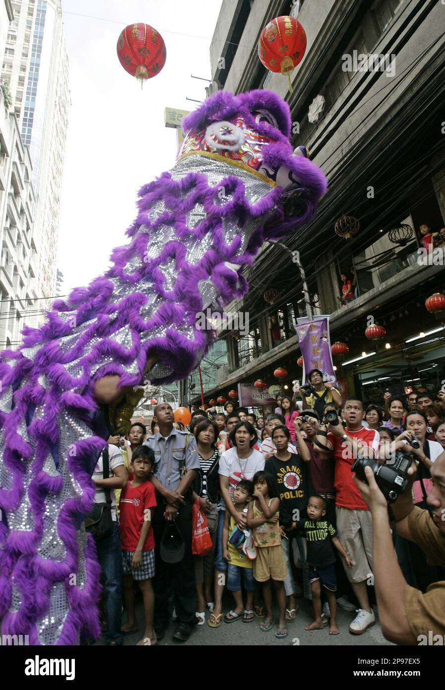 A performer leaps high while performing a dragon dance to celebrate the ...