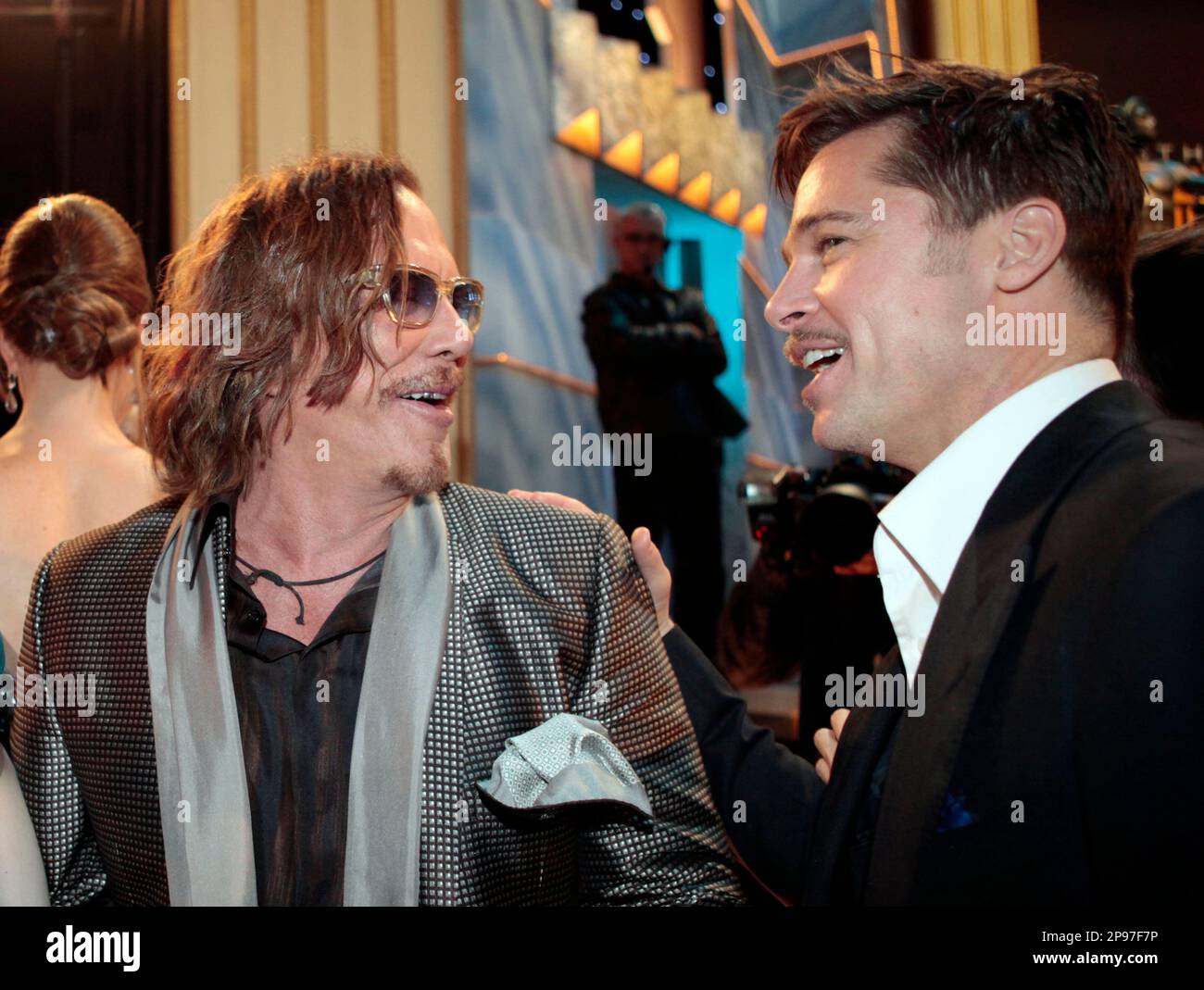 Actors Mickey Rourke, left, and Brad Pitt mingle in the audience during ...