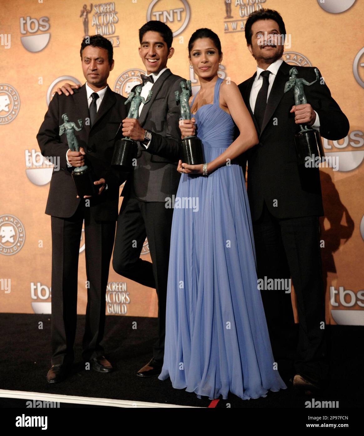 Members of the cast of "Slumdog Millionaire" pose backstage with the ...