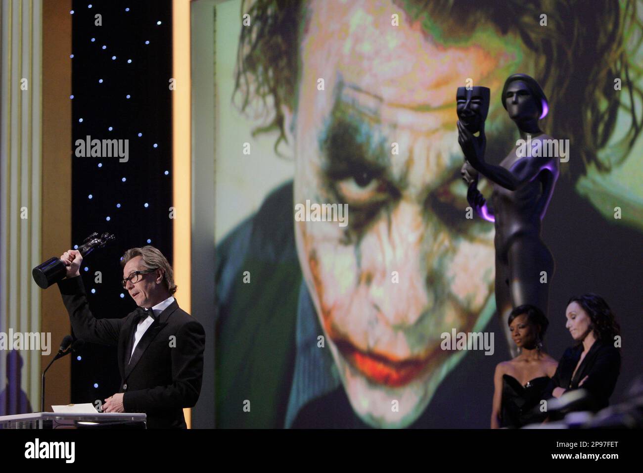 Gary Oldman accepts the male actor in a supporting role award on behalf ...