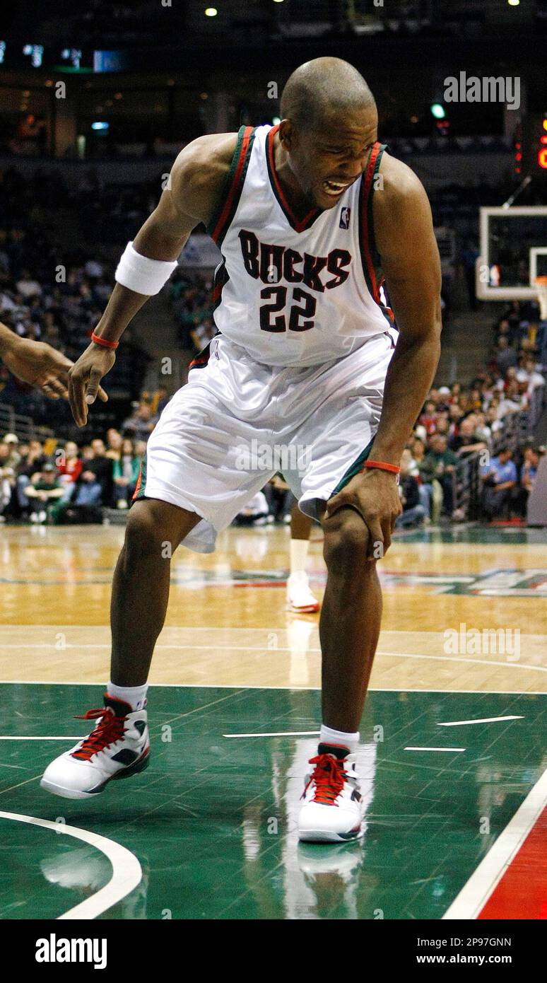 Milwaukee Bucks' Michael Redd grabs his knee after shooting during the ...