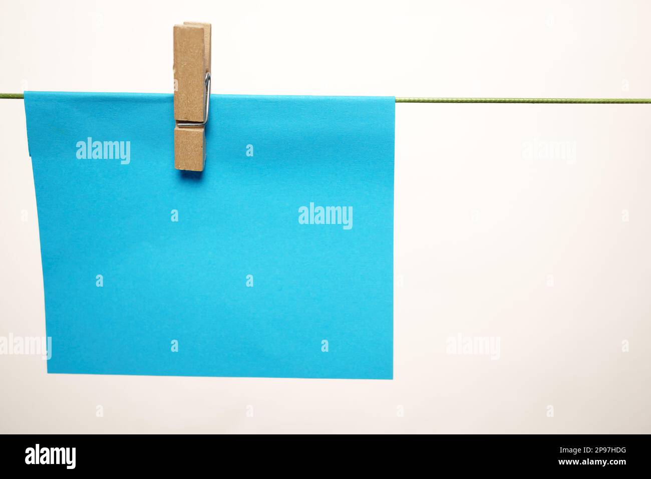 sticky note hung with a clothespin on a clothesline with copy space and ...