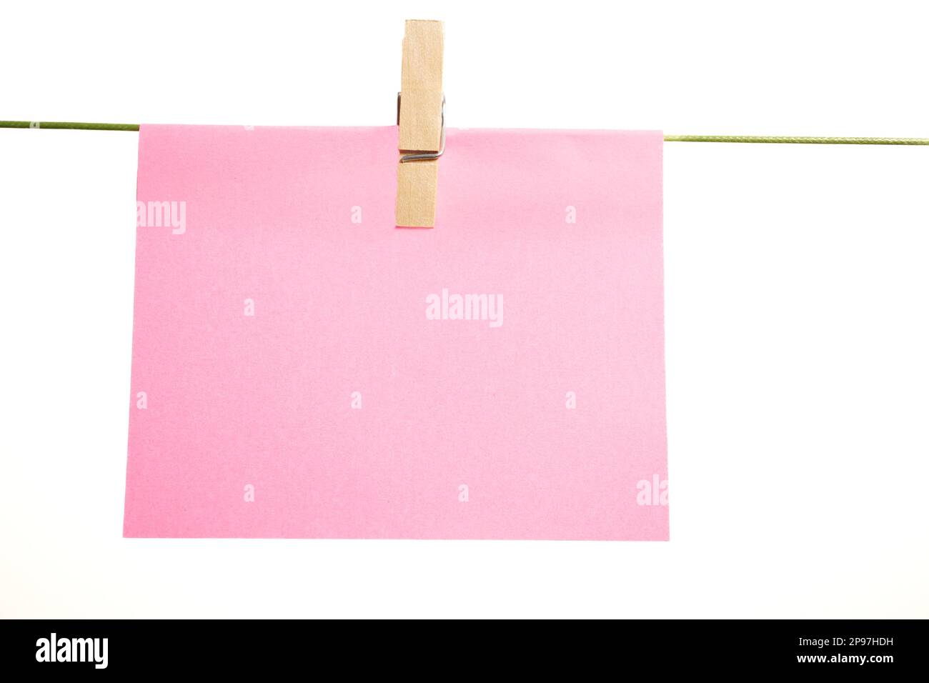 sticky note hung with a clothespin on a clothesline with copy space and ...