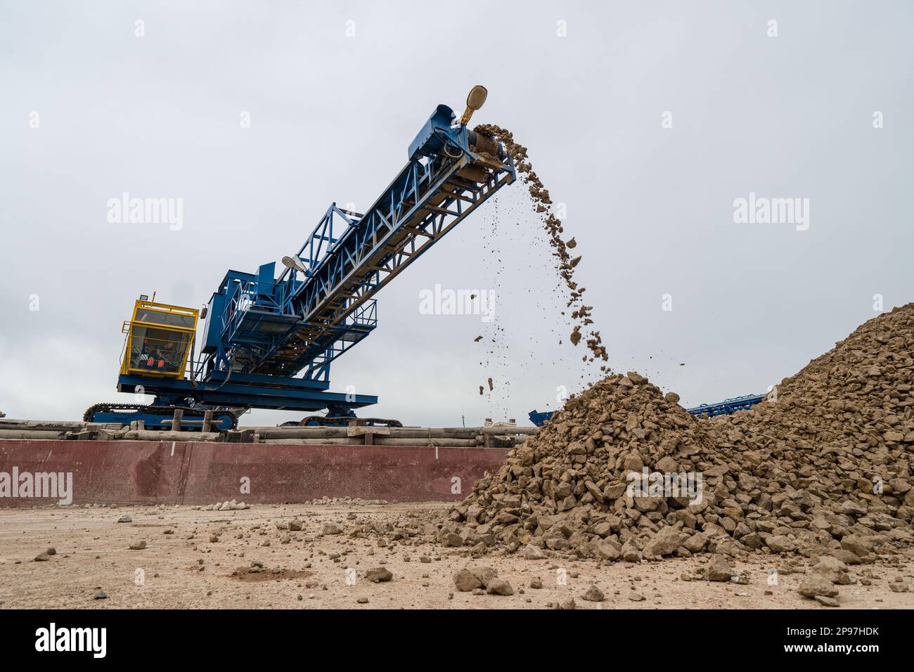 Industrial belt conveyor moving raw materials from mine Stock Photo - Alamy