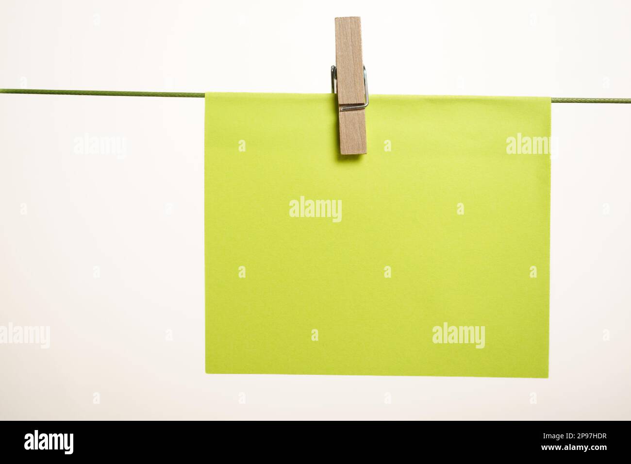 sticky note hung with a clothespin on a clothesline with copy space and ...