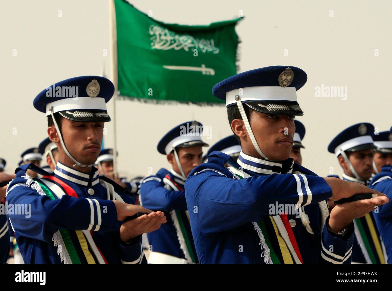Saudi air force officers take an oath on a small Quran during a ...