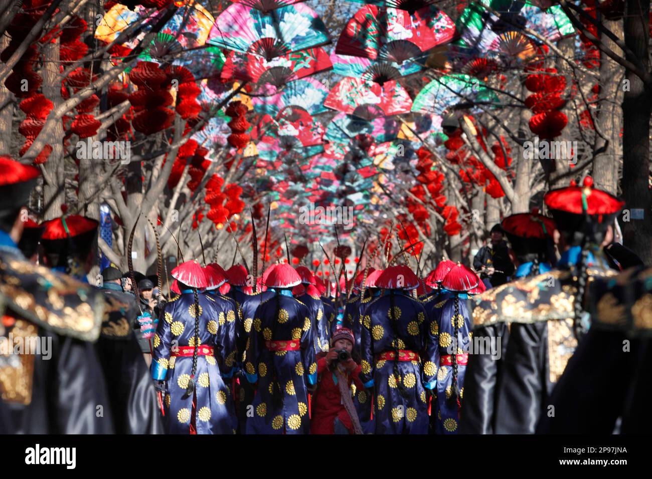 A Chinese woman, center, photographs performers at the opening ceremony ...