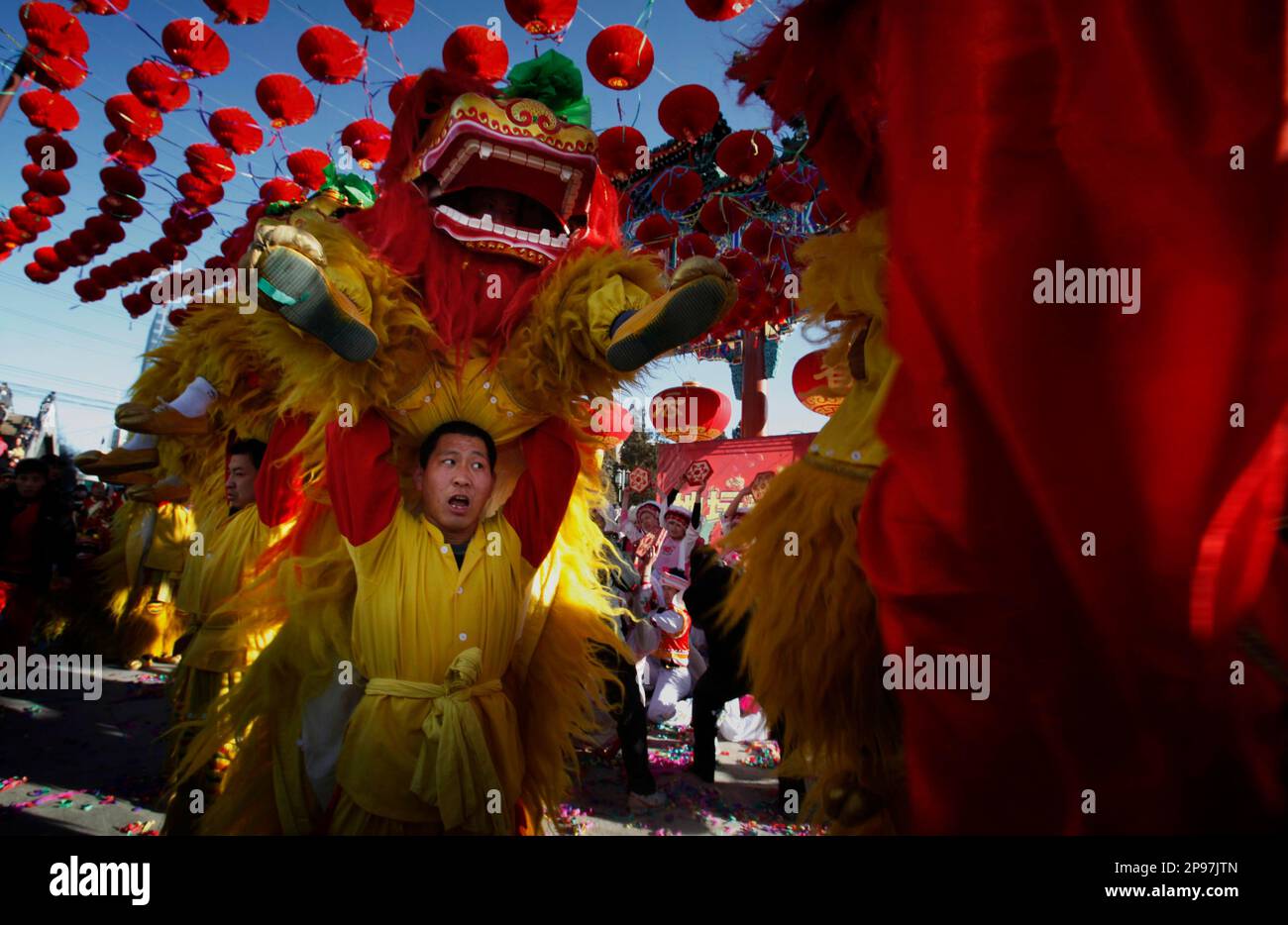 Dancers dressed in traditional Chinese costumes perform lion dance at ...