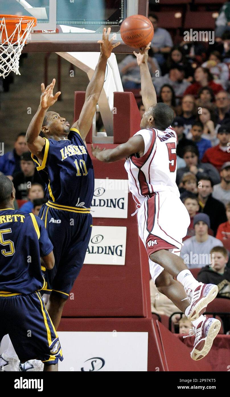 Massachusetts' Ricky Harris shoots as La Salle's Rodney Green defends ...