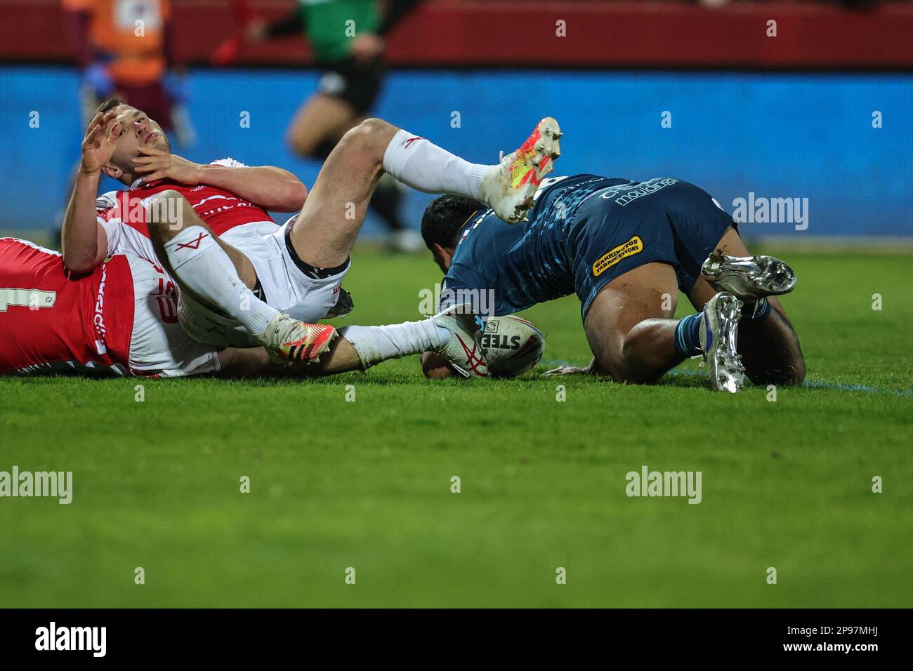 Tom Mikaele #18 of Warrington Wolves goes over for a try during the ...