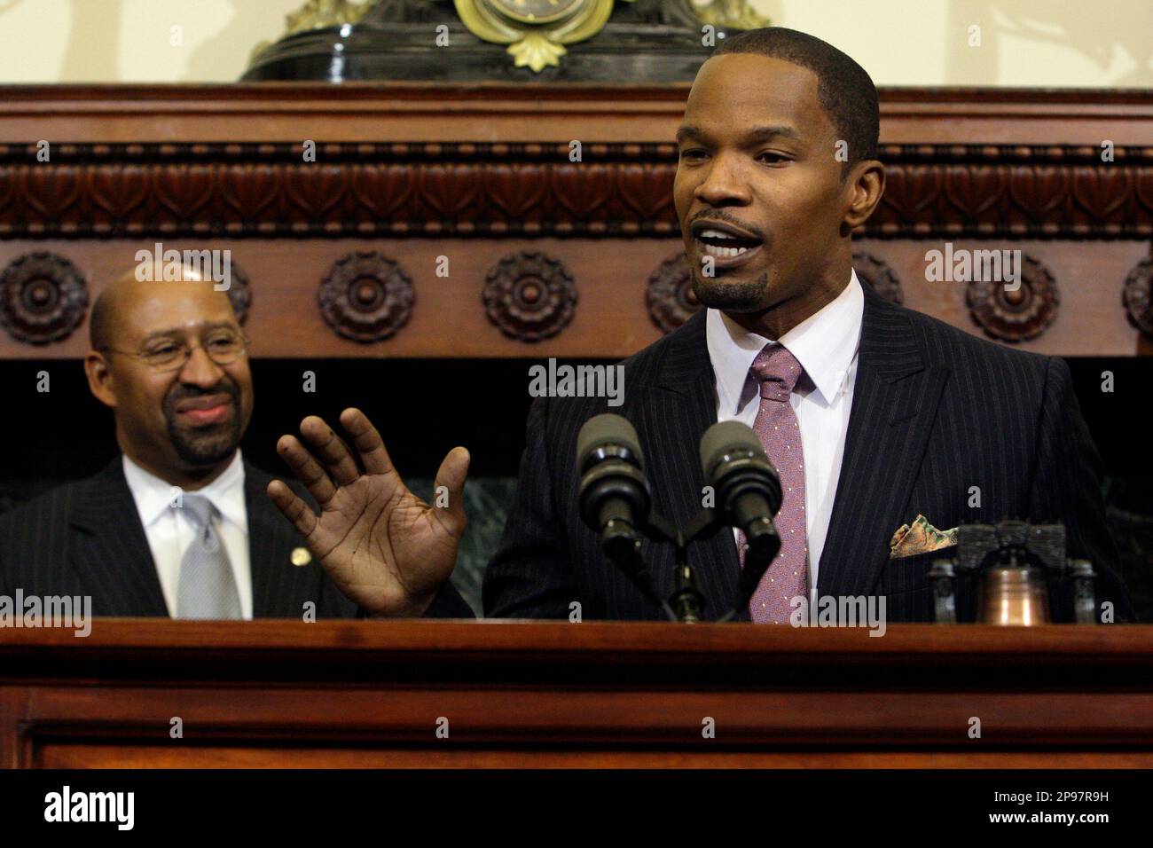 Actor Jamie Foxx, right, makes remarks as Mayor Michael Nutter looks on ...