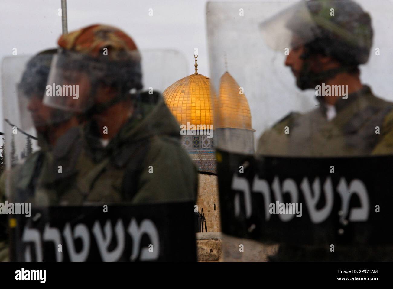 Israeli police officers stand guard as the Dome of the Rock Mosque is ...