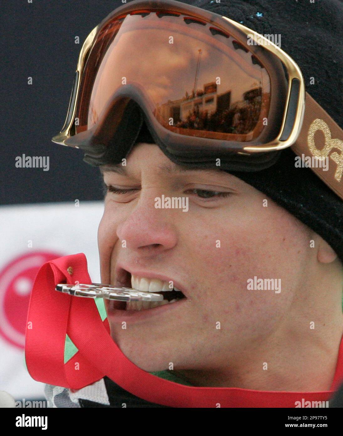 Jeff Batchelor of Canada bites his silver medal during the awarding ...