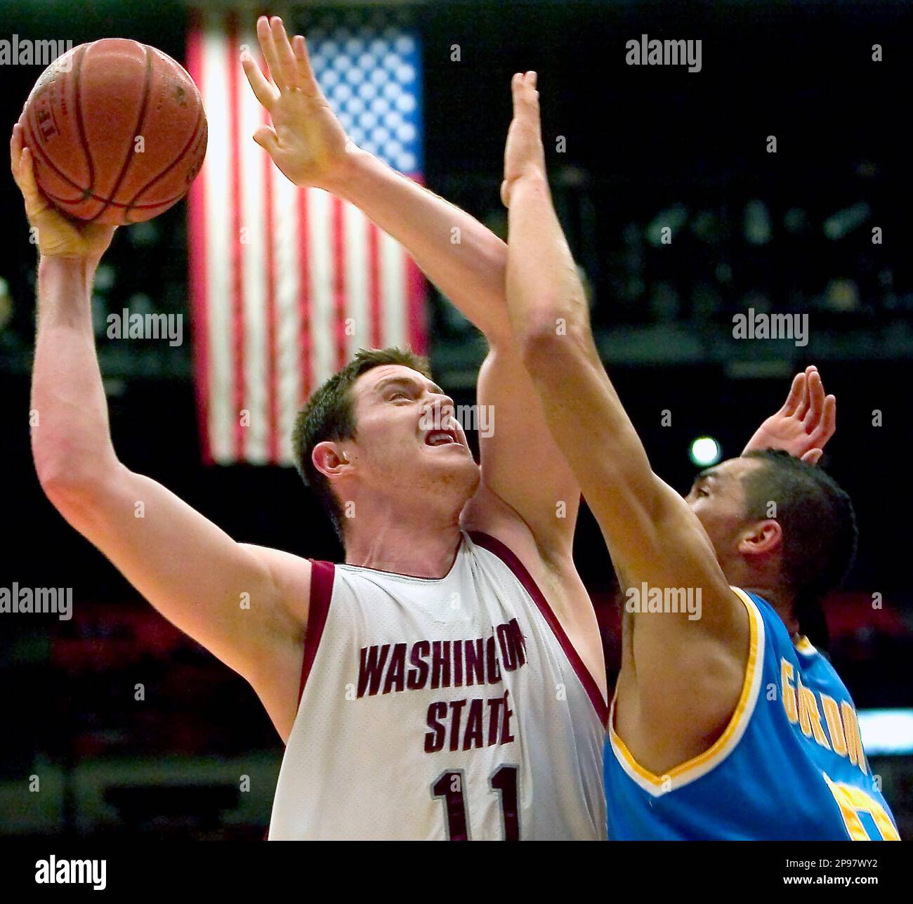 Washington State center Aron Baynes, left, shoots over UCLA forward ...
