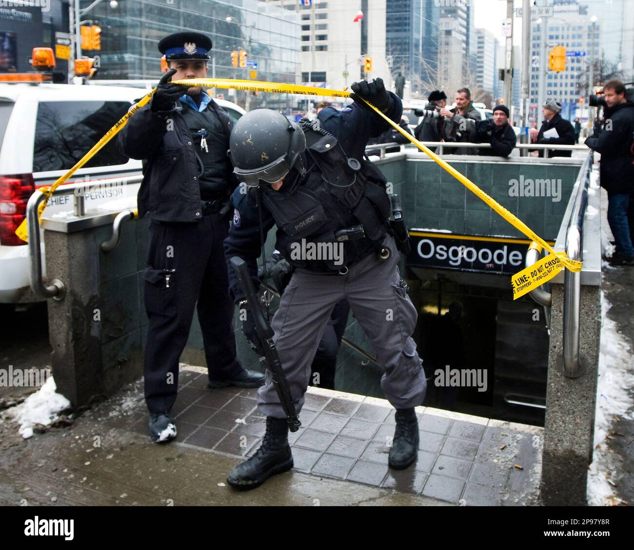 Toronto tactical police officers leave the entrance of the Osgoode ...