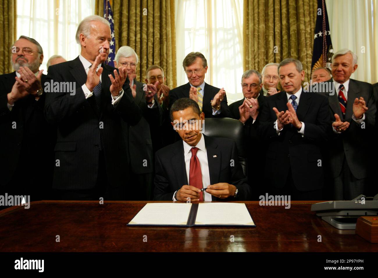 President Barack Obama caps his pen after he signed an executive order ...