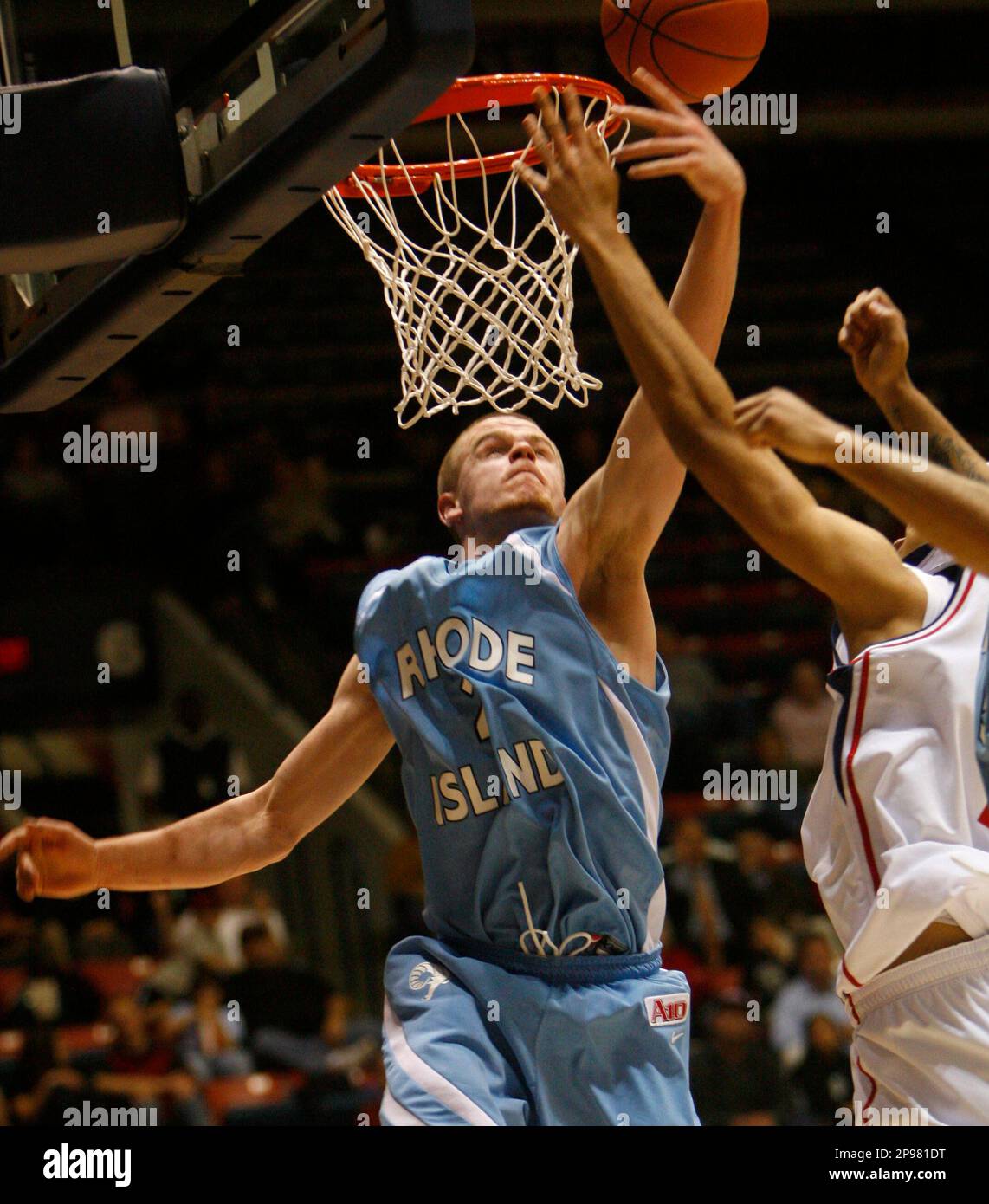 Rhode Island's Ben Eaves, left, goes up for a rebound against Richmond ...