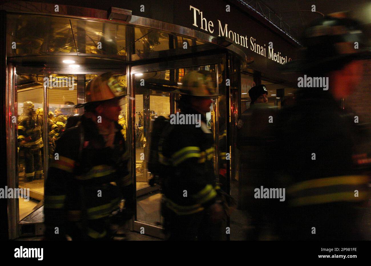 Firefighters are seen inside and outside an entrance to The Mount Sinai ...