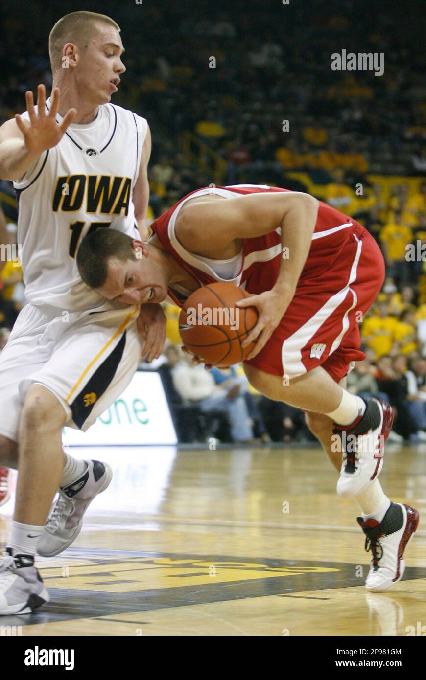Wisconsin's Jason Bohannon trips and runs into Iowa's Devan Bawinkel ...