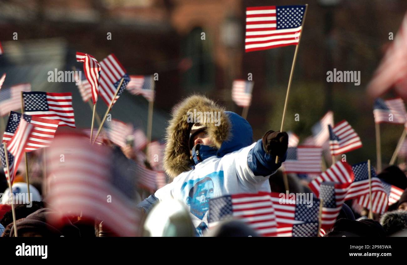 A child waves a flag as Barack Obama takes the stage during ...