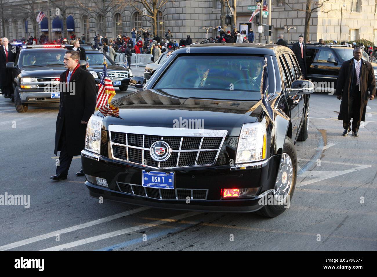 U.S. Secret Service agents walk alongside the new presidential ...